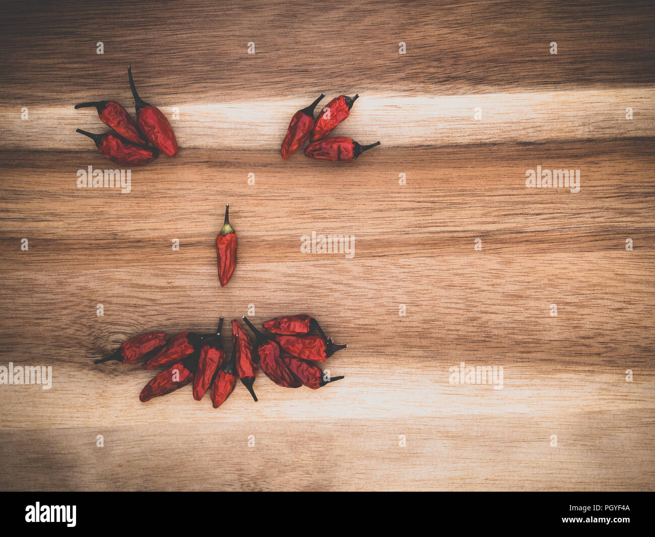 Chilies in the shape of a scary halloween face on wooden board Stock ...