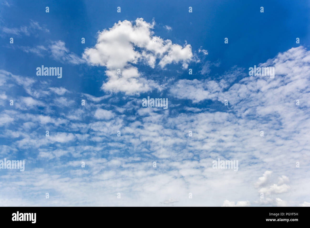 Fluffy white clouds in a blue sky Stock Photo - Alamy