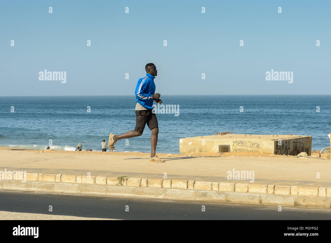 DAKAR, SENEGAL - APR 23, 2017: Unidentified Senegalese man runs along ...