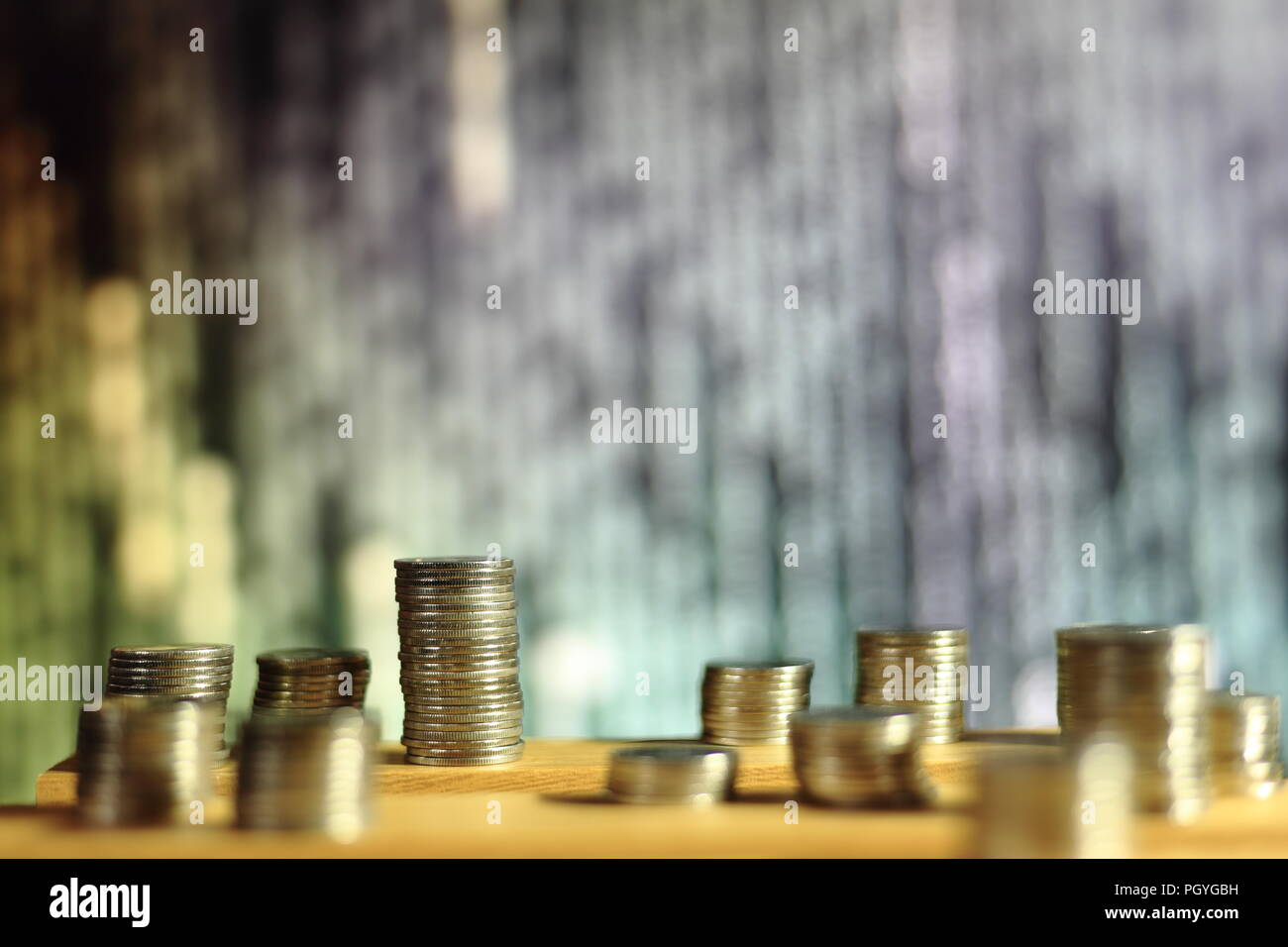 secured internet business. big coin piles in front of blue binary code ...