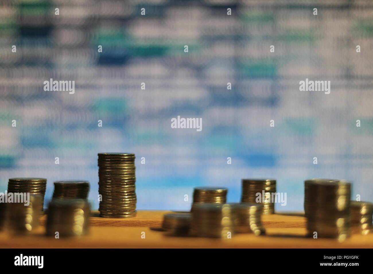 secured internet business. big coin piles in front of blue binary code ...