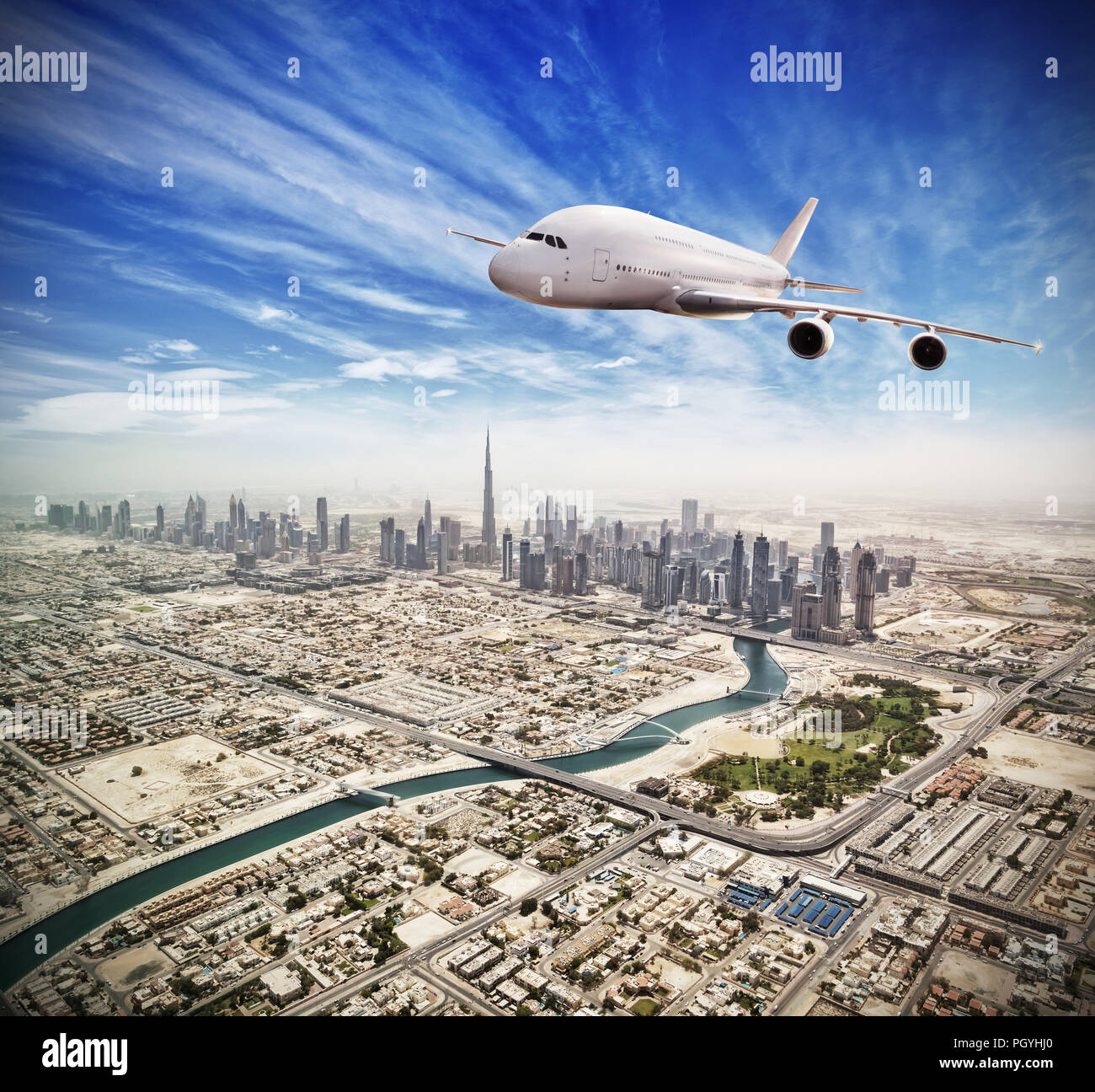 Huge commercial jetliner flying above Dubai city, UAE. Modern and ...