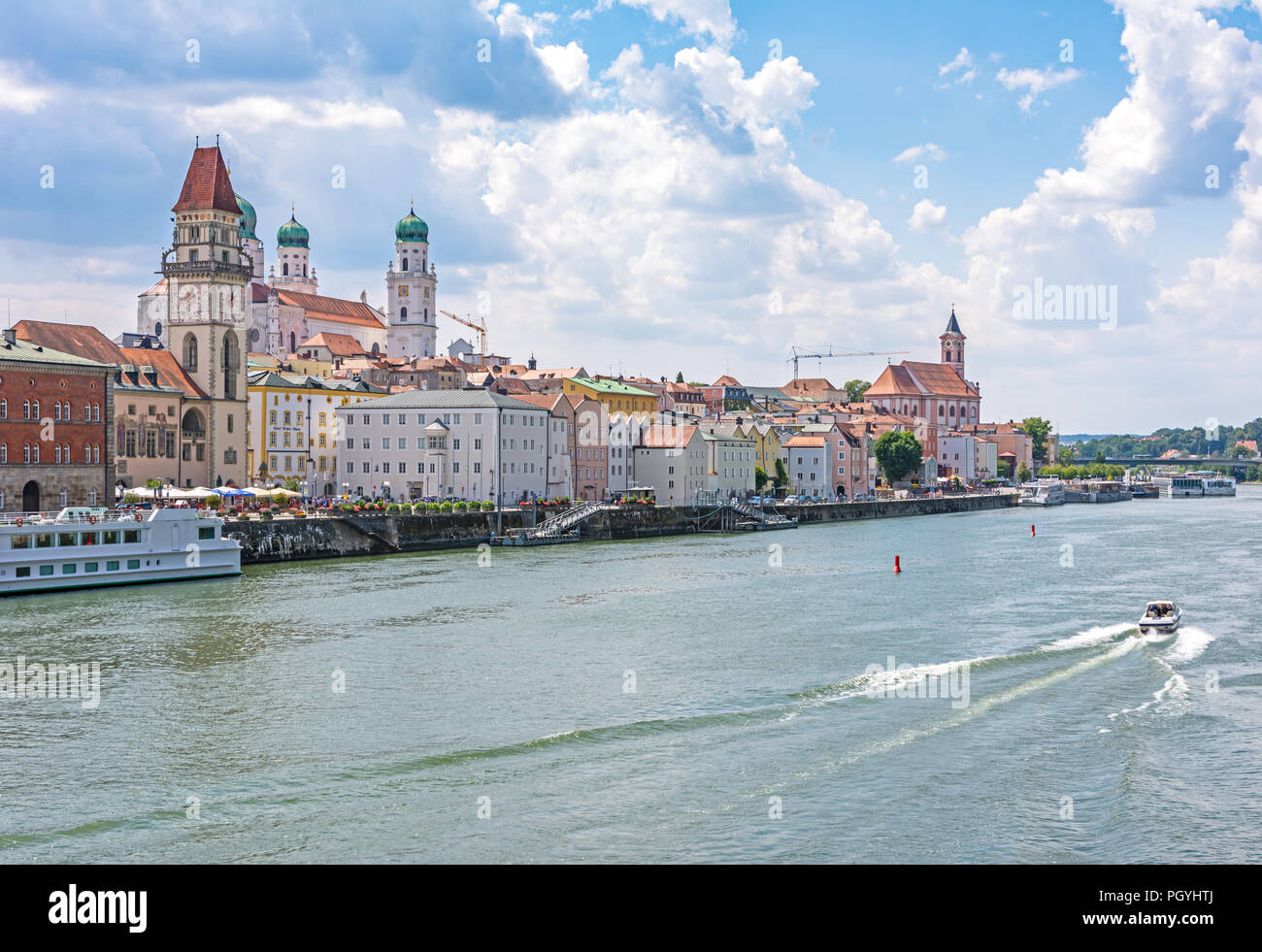 PASSAU, GERMANY - JULY 14: Small ship crouising along the waterfront of ...