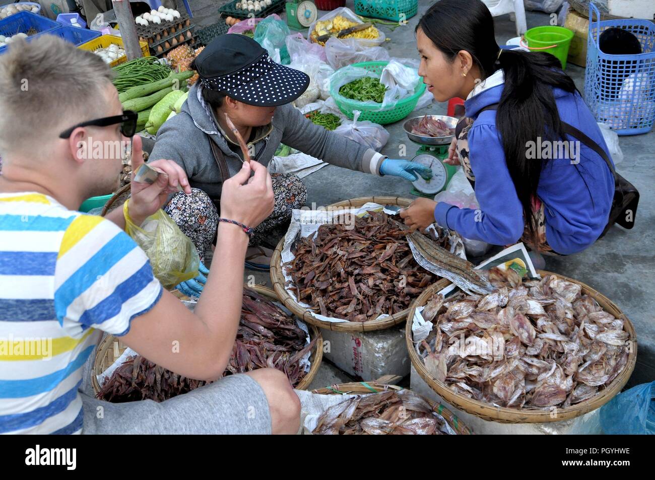 Tourist buying from locals Stock Photo - Alamy