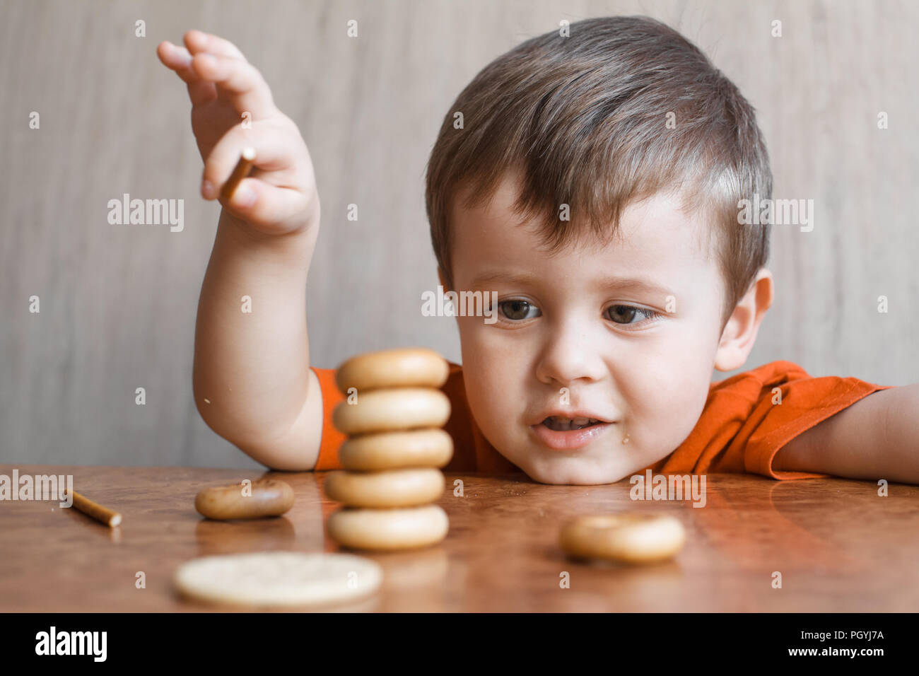 Cute little boy is playing with Bagel Stock Photo - Alamy