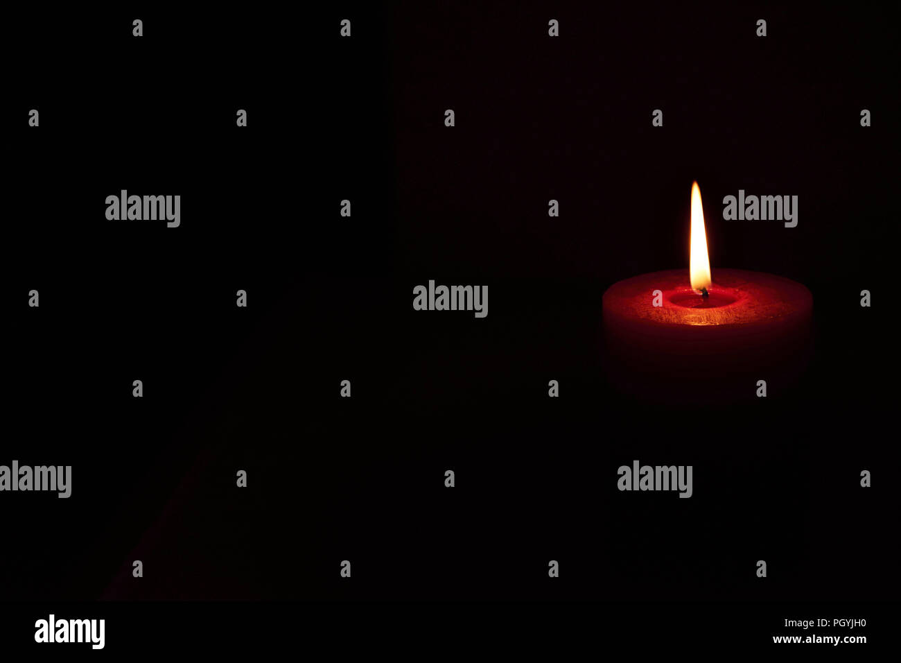 Candle in complete darkness Stock Photo - Alamy