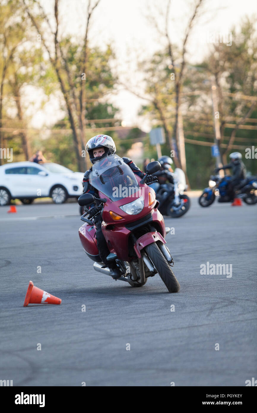 Front view at motorcyclist driving and turning on motordrome through ...