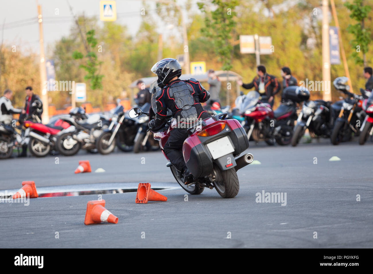 Motorcycle driver riding bike on urban square using it as motordrome ...