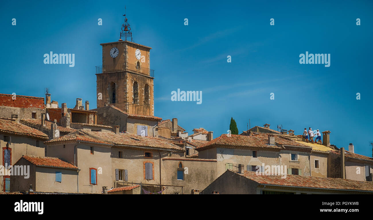 Roofing contractors replace pantile roof tiles on old building in the ...