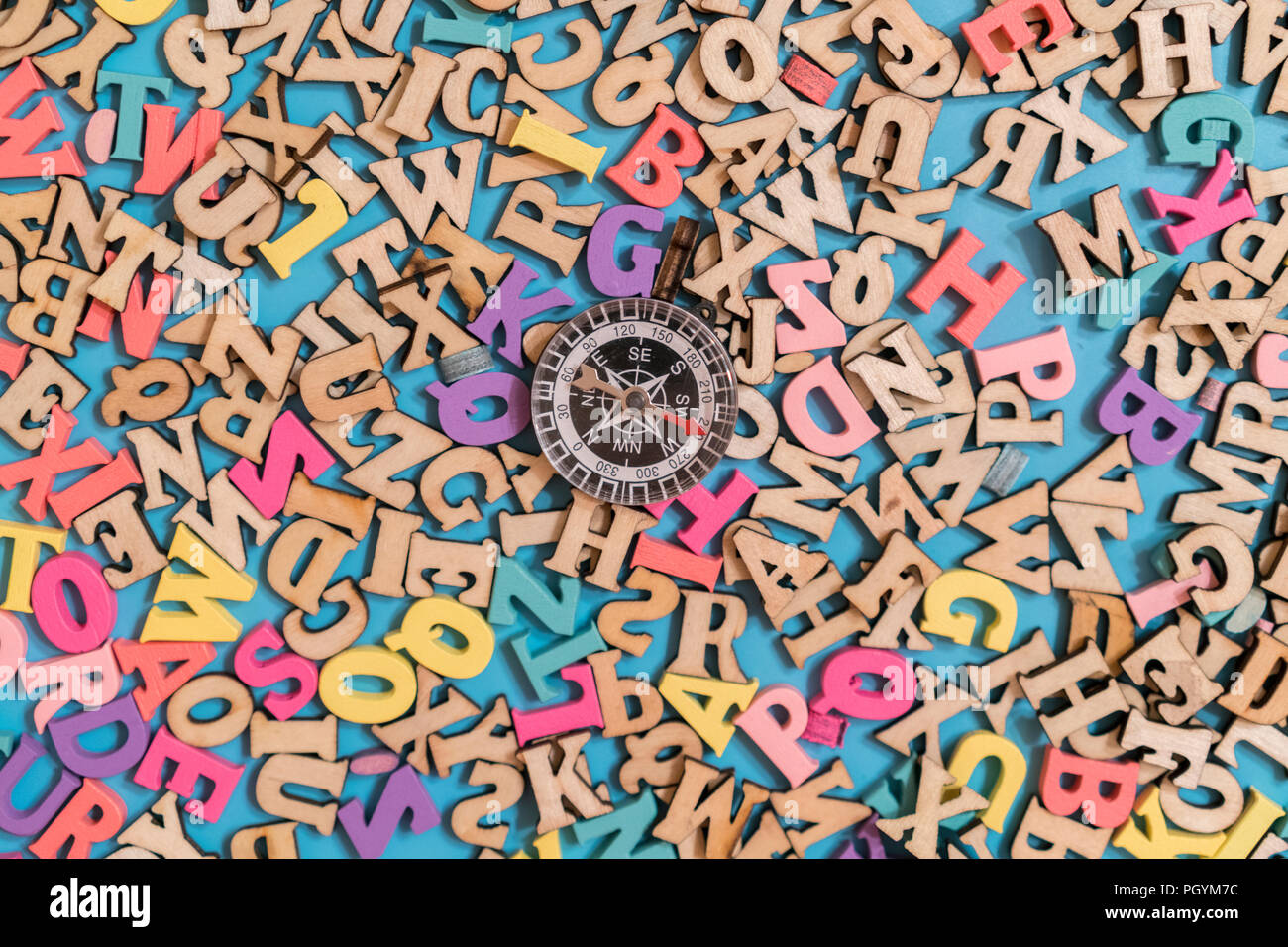 multicolored wooden letters of the English alphabet on a blue ...