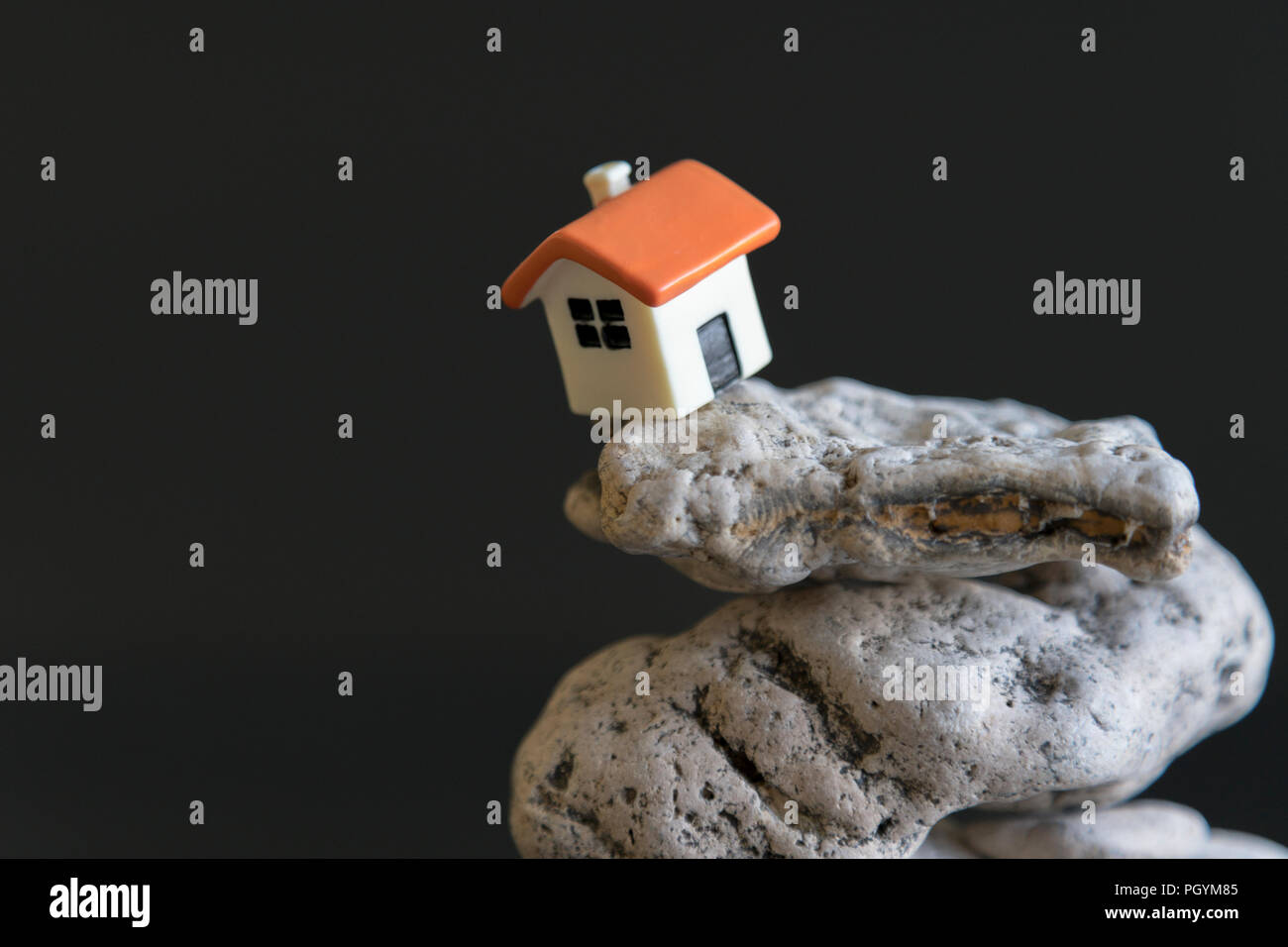 house on the edge of the abyss on a black background. The concept of a ...