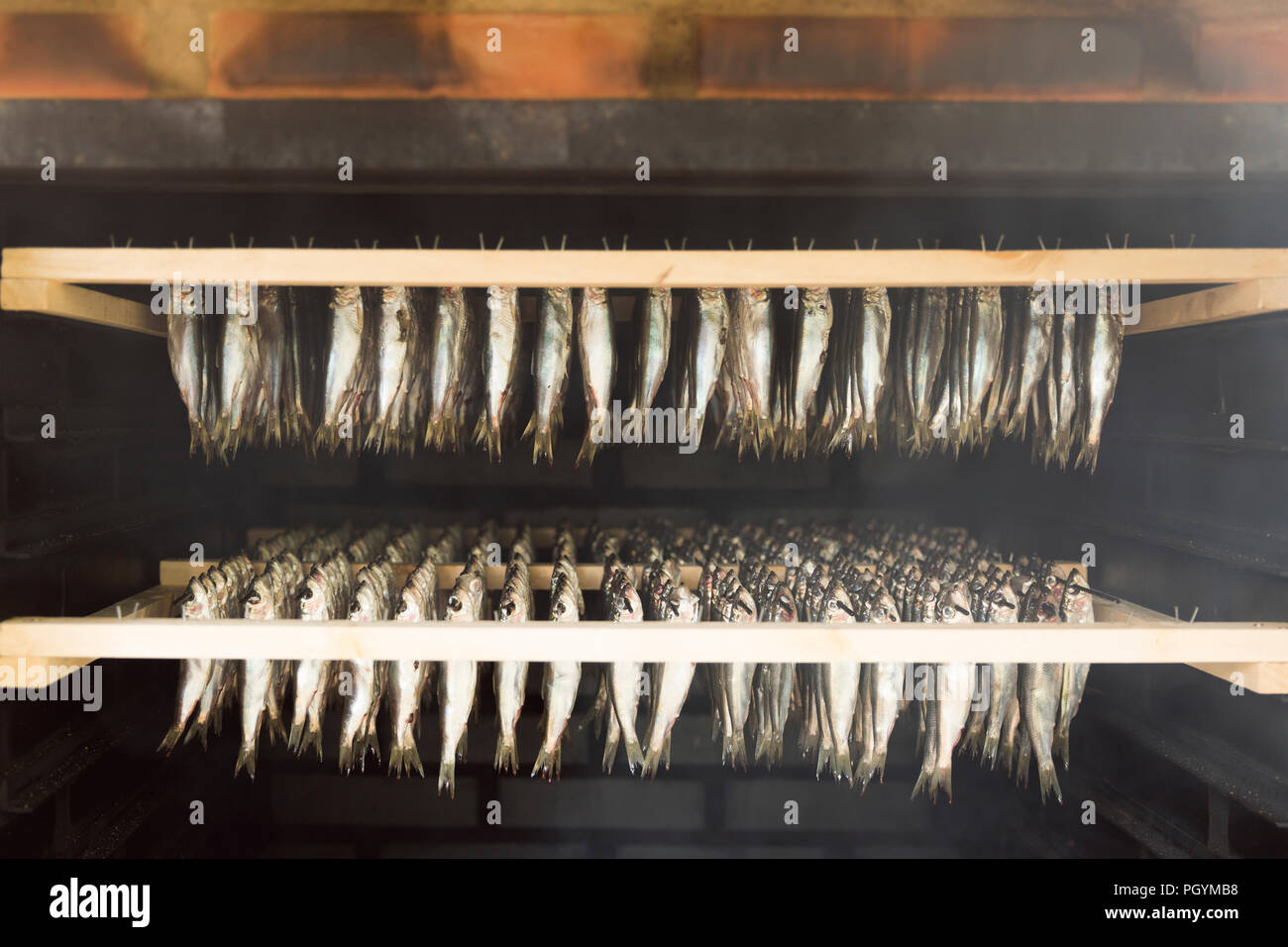 Smoked fish hanging in a smokehouse Stock Photo - Alamy