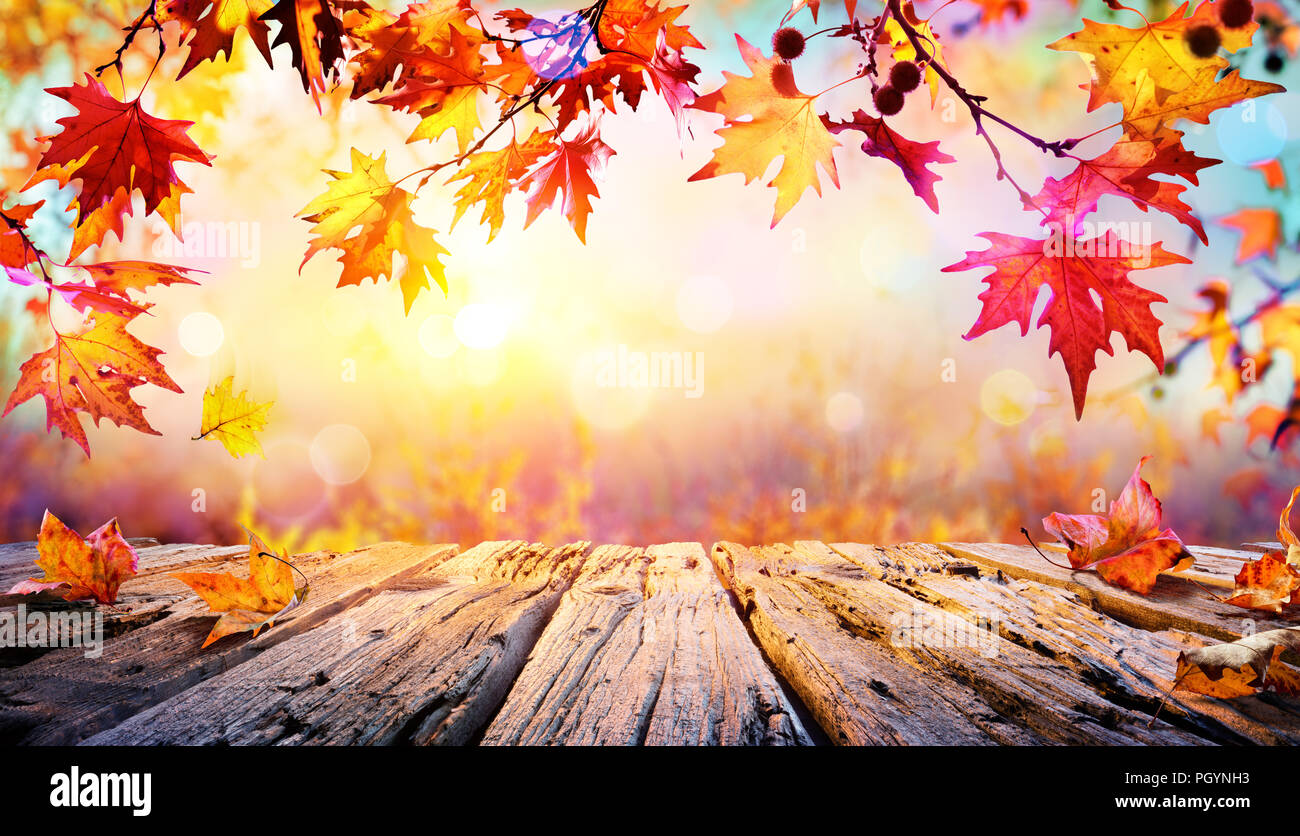 Wooden Table With Red Leaves And Autumn Background Stock Photo - Alamy