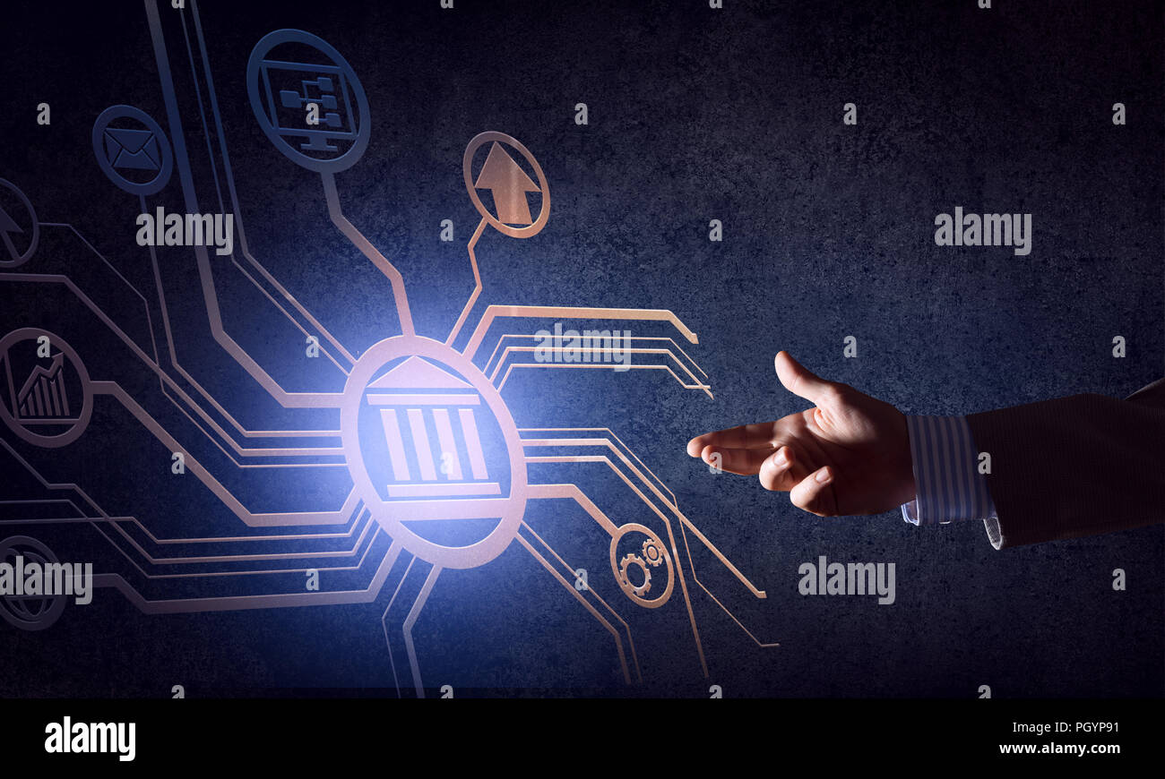 Businessman hand pointing on virtual screen over dark concrete ...