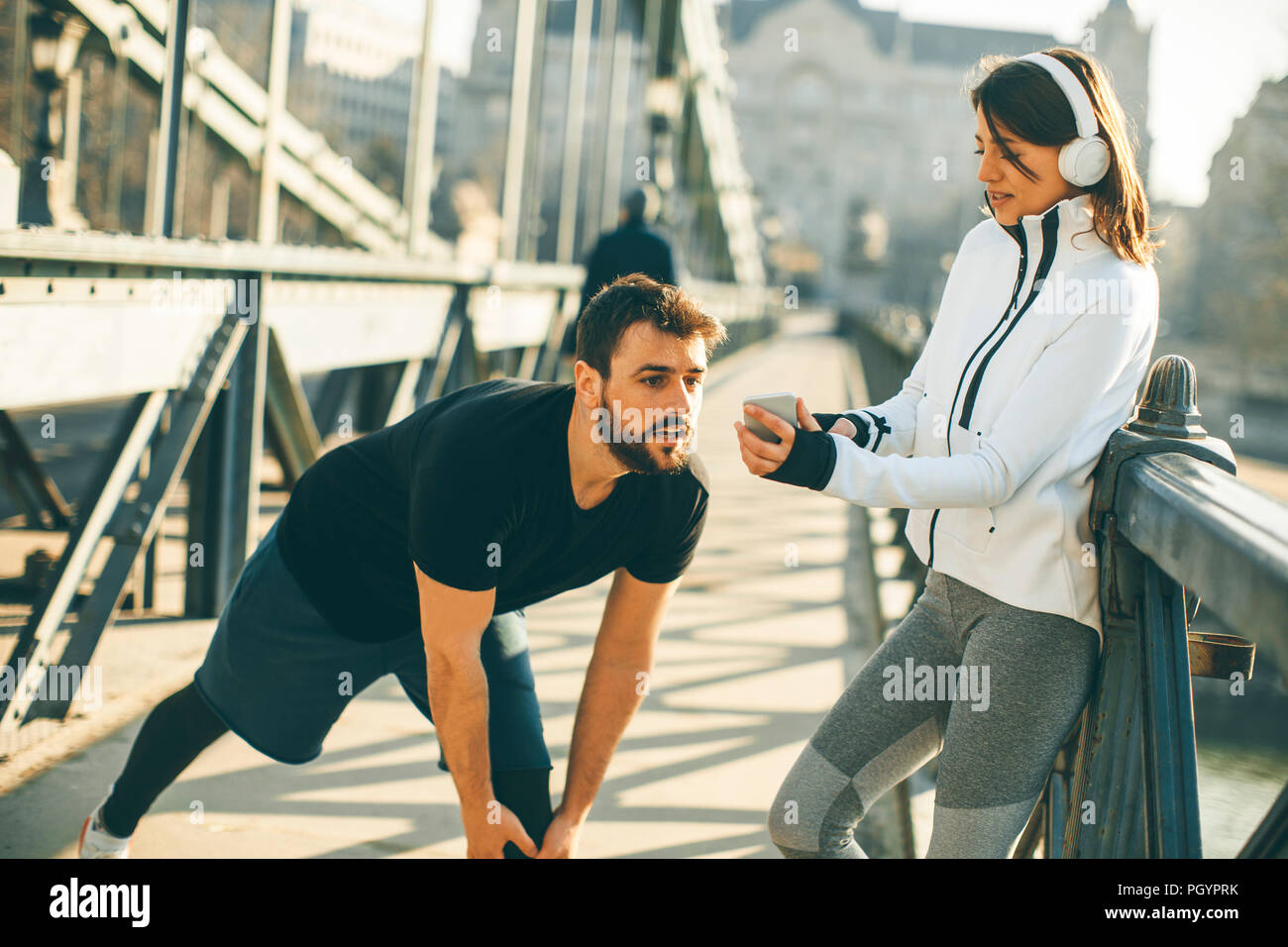 Young handsome couple have training in urban enviroment at sunny day ...