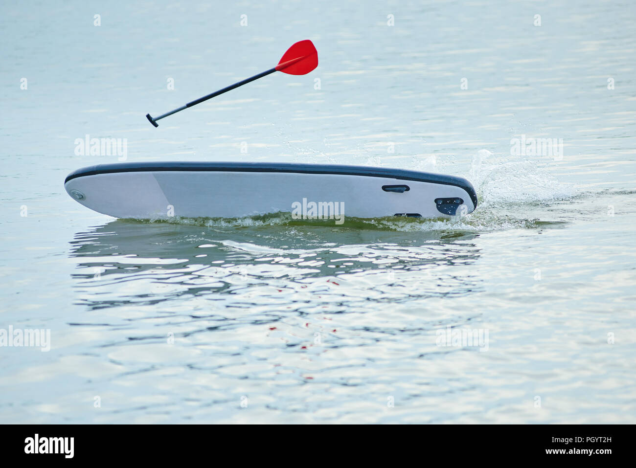 Red oar flying over sup board, swimming withot a man, who felt in water ...