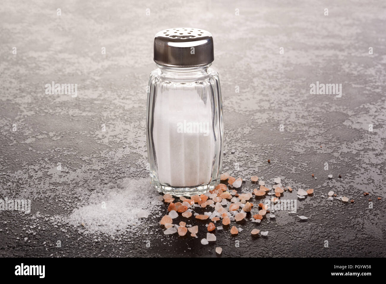 Culinary himalayan and normal salt on table and in shaker Stock Photo ...