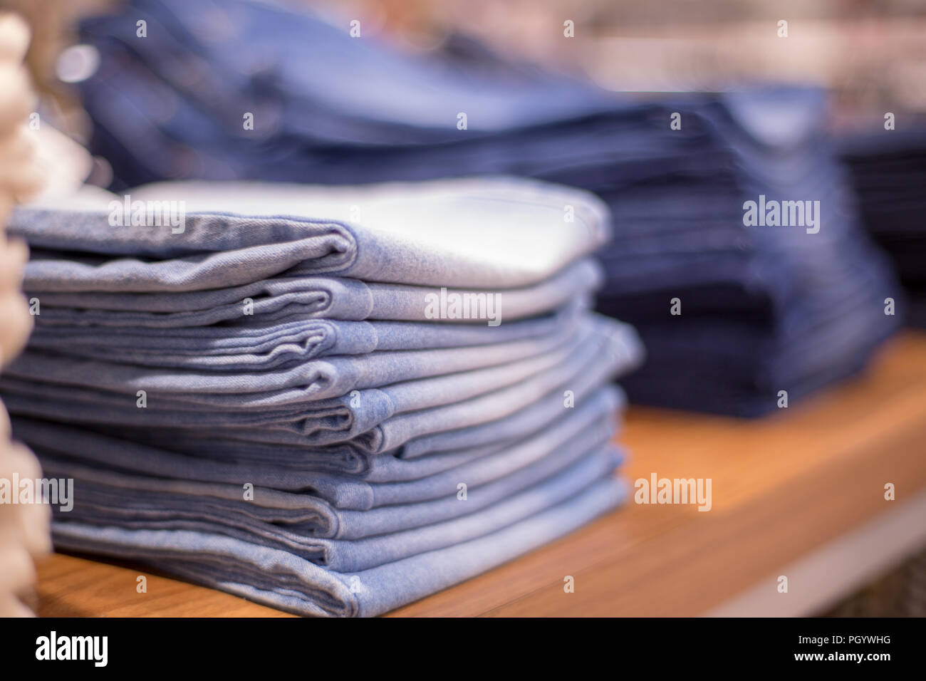 Pile Of Folded Blue Denim Jeans Closeup In A Variety Of Shades Stock ...
