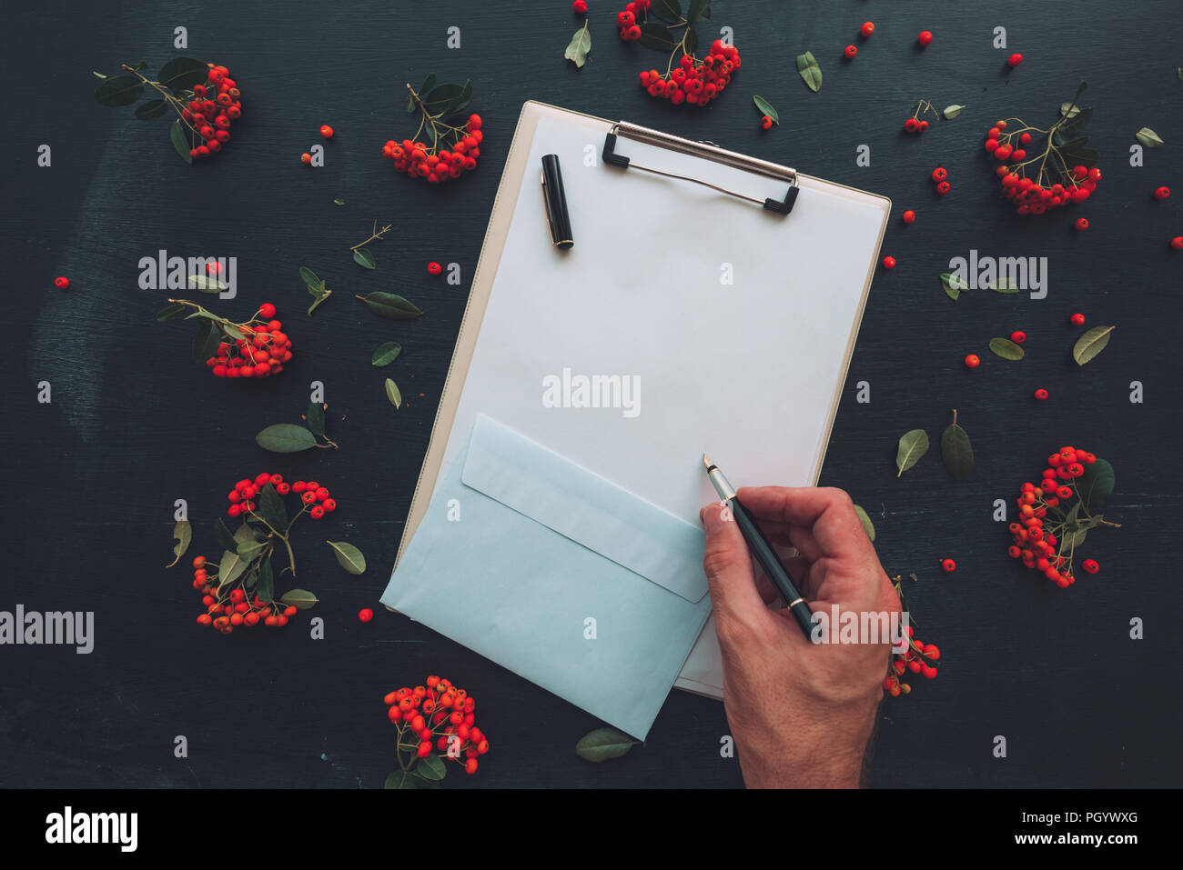 Flat lay hand writing letter on clipboard notepad and mail envelope ...