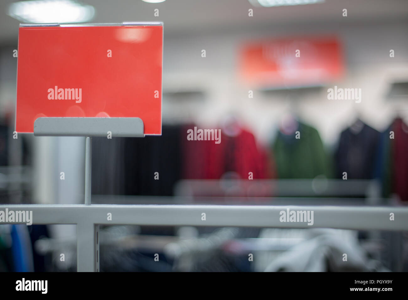 Red sign on a shop. Space for text. Sale in a clothing store. Copy ...