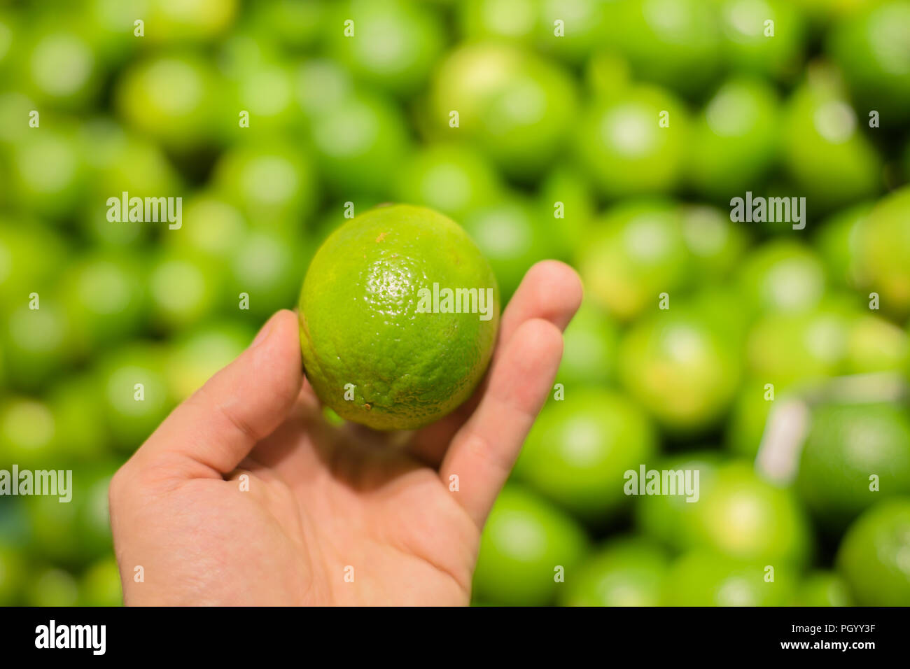 Fresh green lemons in supermarket Stock Photo - Alamy