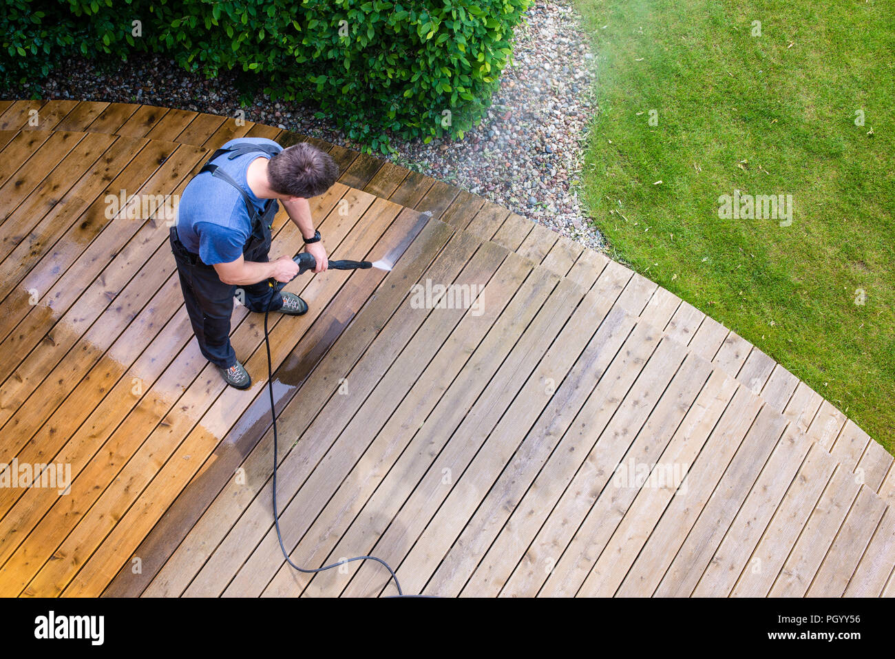 man cleaning terrace with a power washer - high water pressure cleaner ...