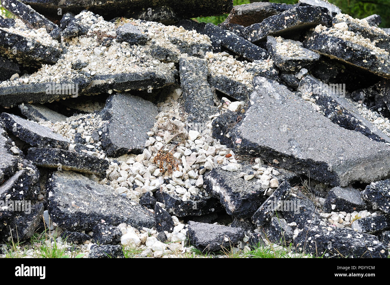 heap of broken tarmac pieces beside site of destruction work Stock ...