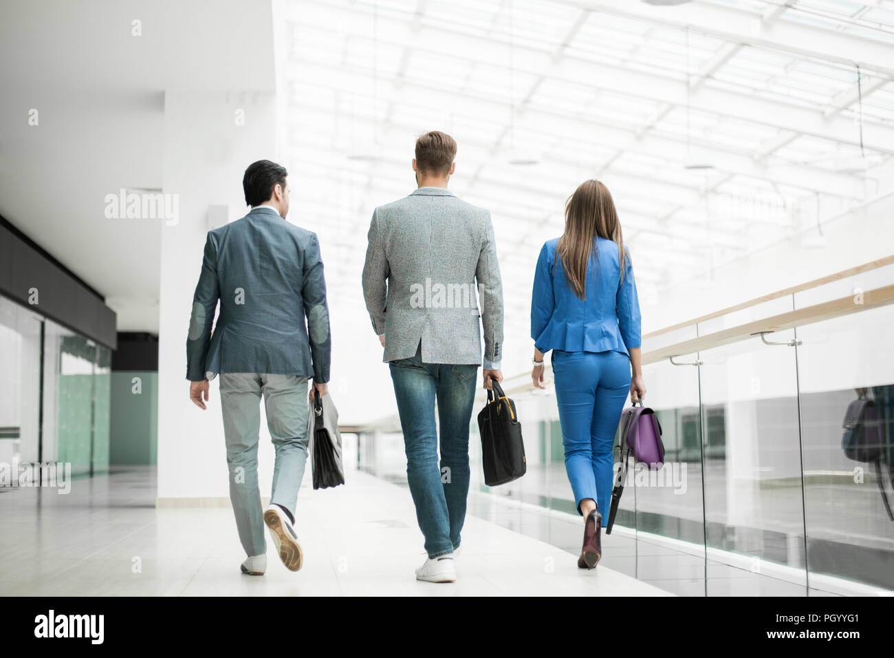 rear view.the business team are walking together Stock Photo - Alamy