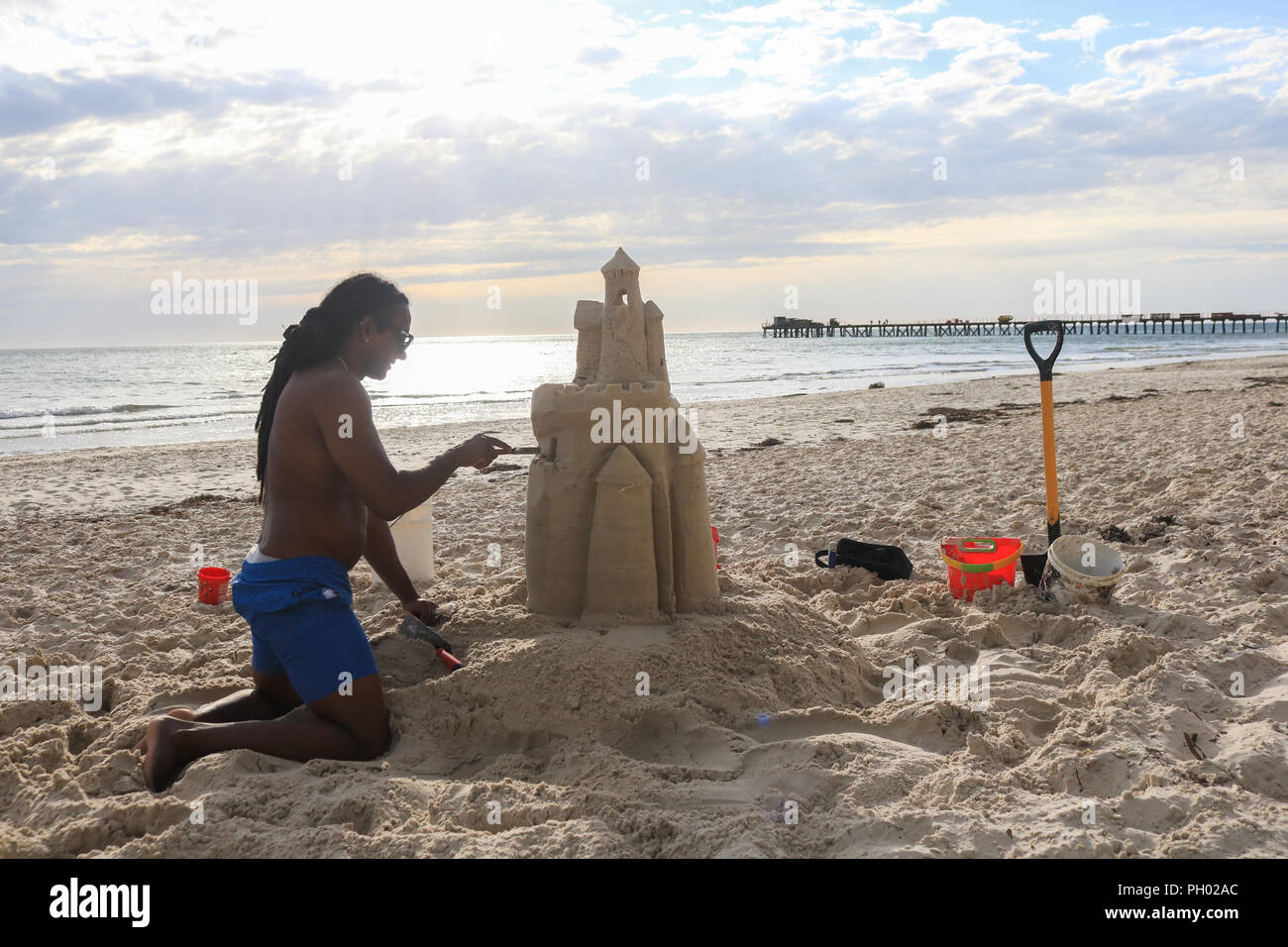 Man building sandcastles on the beach hi-res stock photography and ...