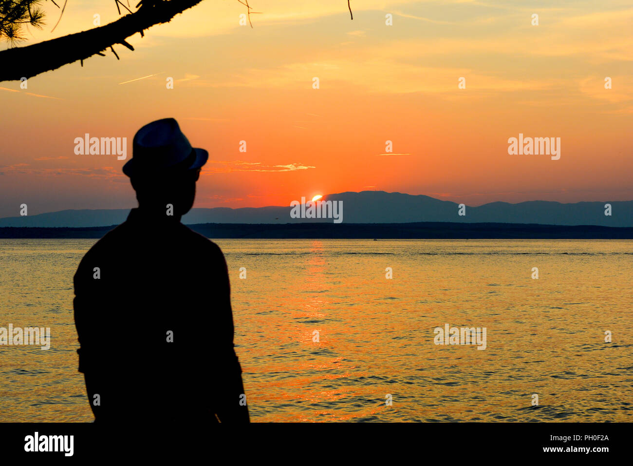 Silhouette of a man at the beautiful sunset on the Beach. Background ...