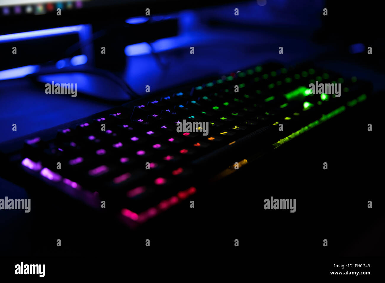 Close up view of workplace with led rainbow backlight gaming usb ...