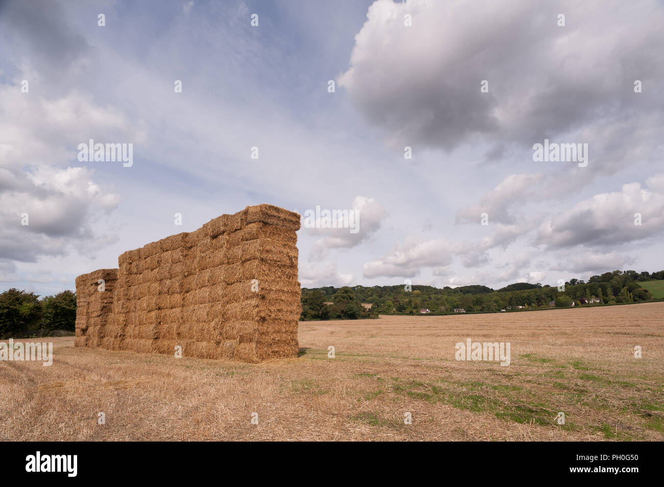 Massive tall 8 bale high stack of straw, one bale deep at risk of ...