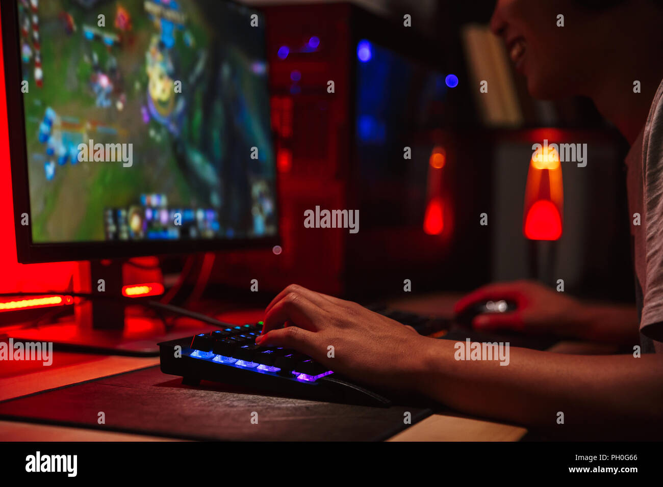 Photo of young gamer guy looking at screen and playing video games on ...