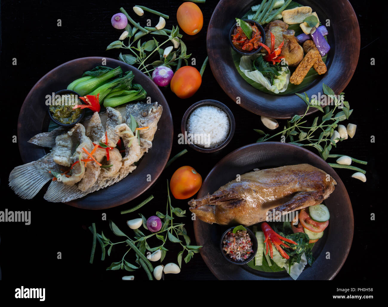 Many different various dishes top view. Fish, duck, chiken on dark ...