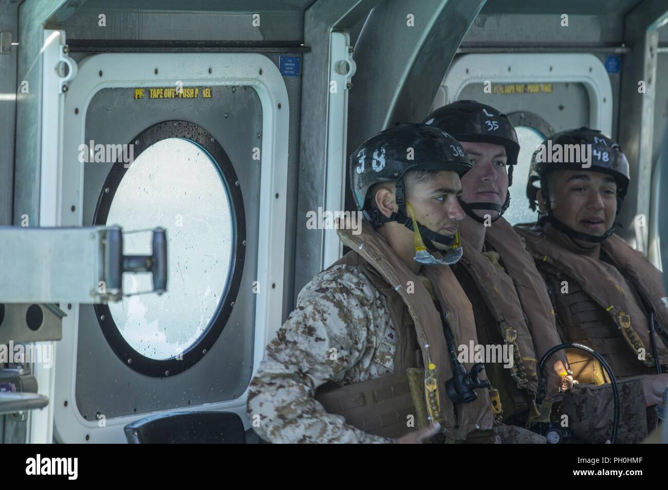 Marines with 3rd Battalion, 5th Marine Regiment, sit inside of the ...