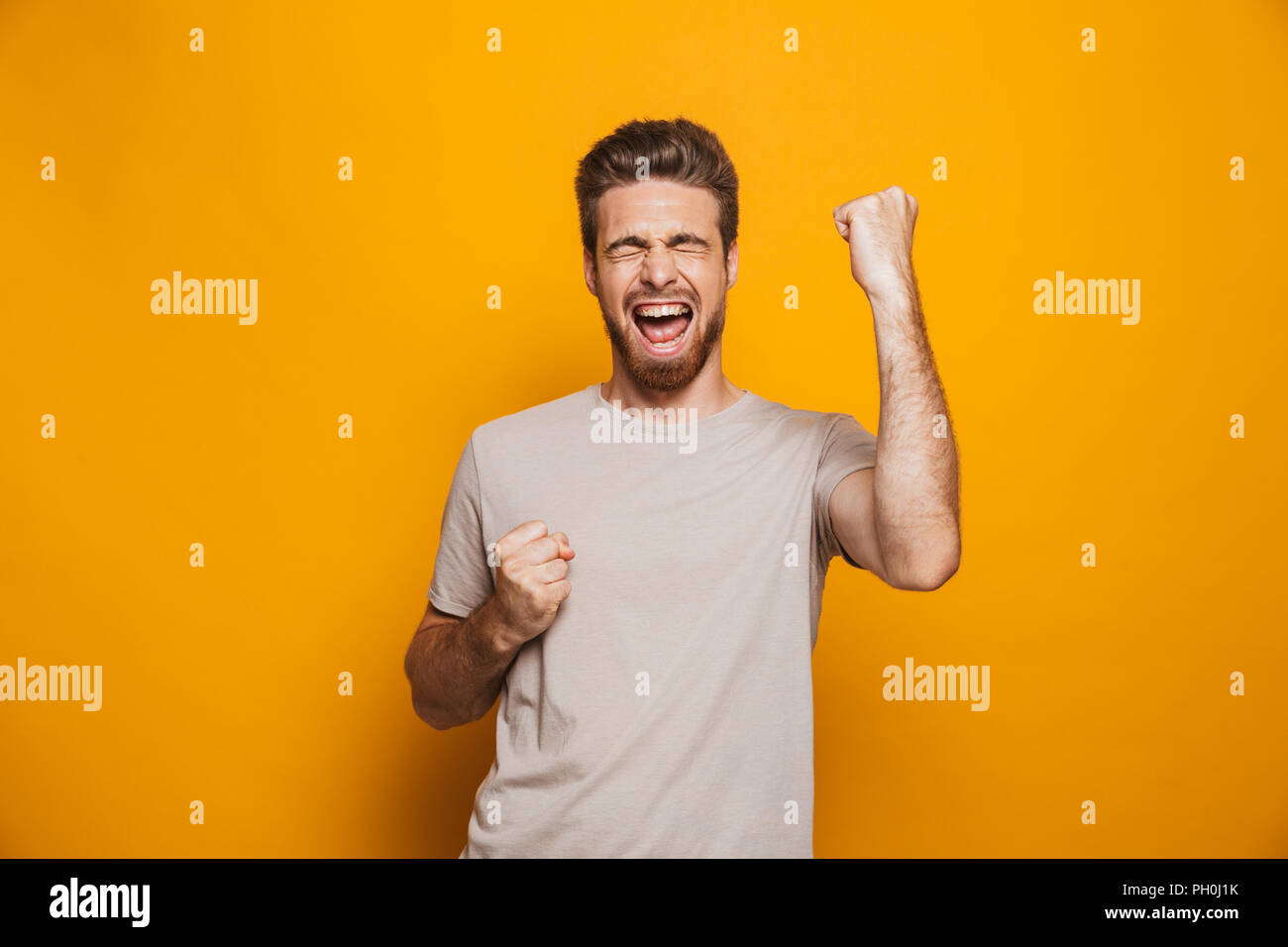Image of handsome happy man standing isolated over yellow wall ...