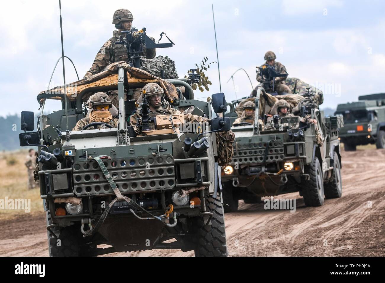 A convoy of Mobility Weapon-Mounted Installation Kit “Jackals” with the ...