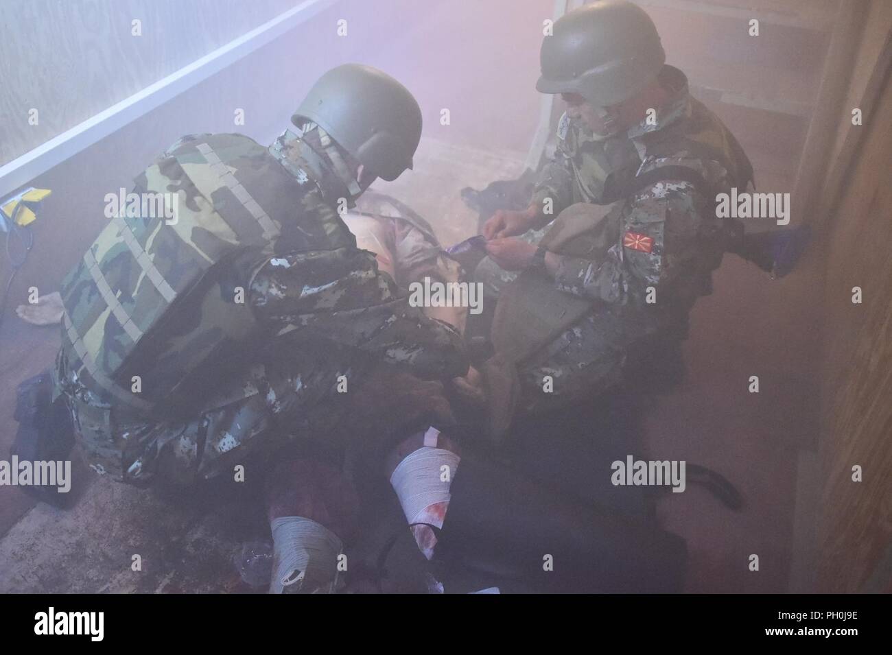 Macedonian soldiers apply first aid to a simulated casualty at the ...