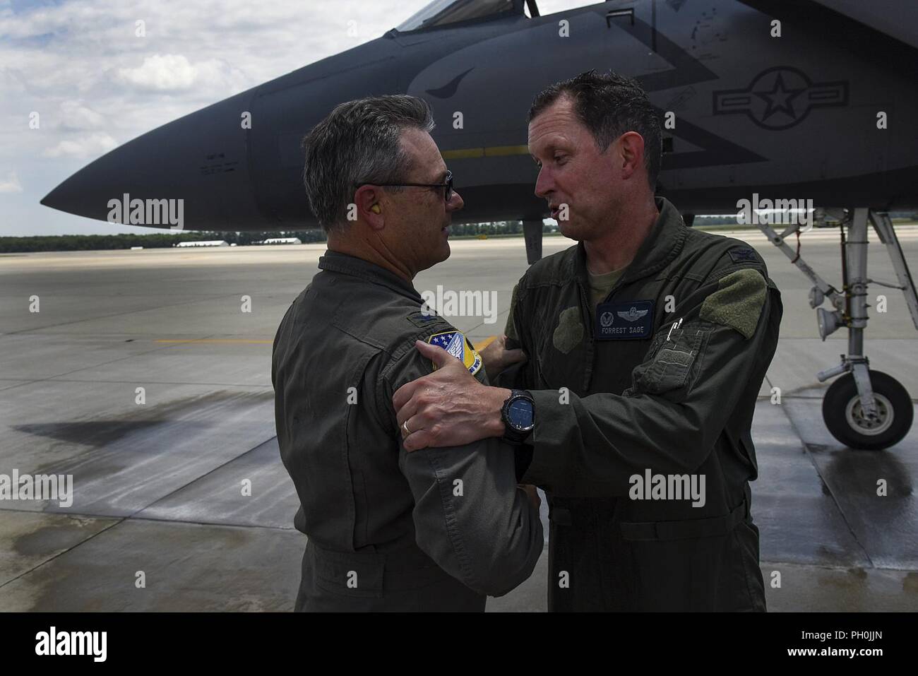 Col. Christopher Sage (right), 4th Fighter Wing commander, shakes hands ...
