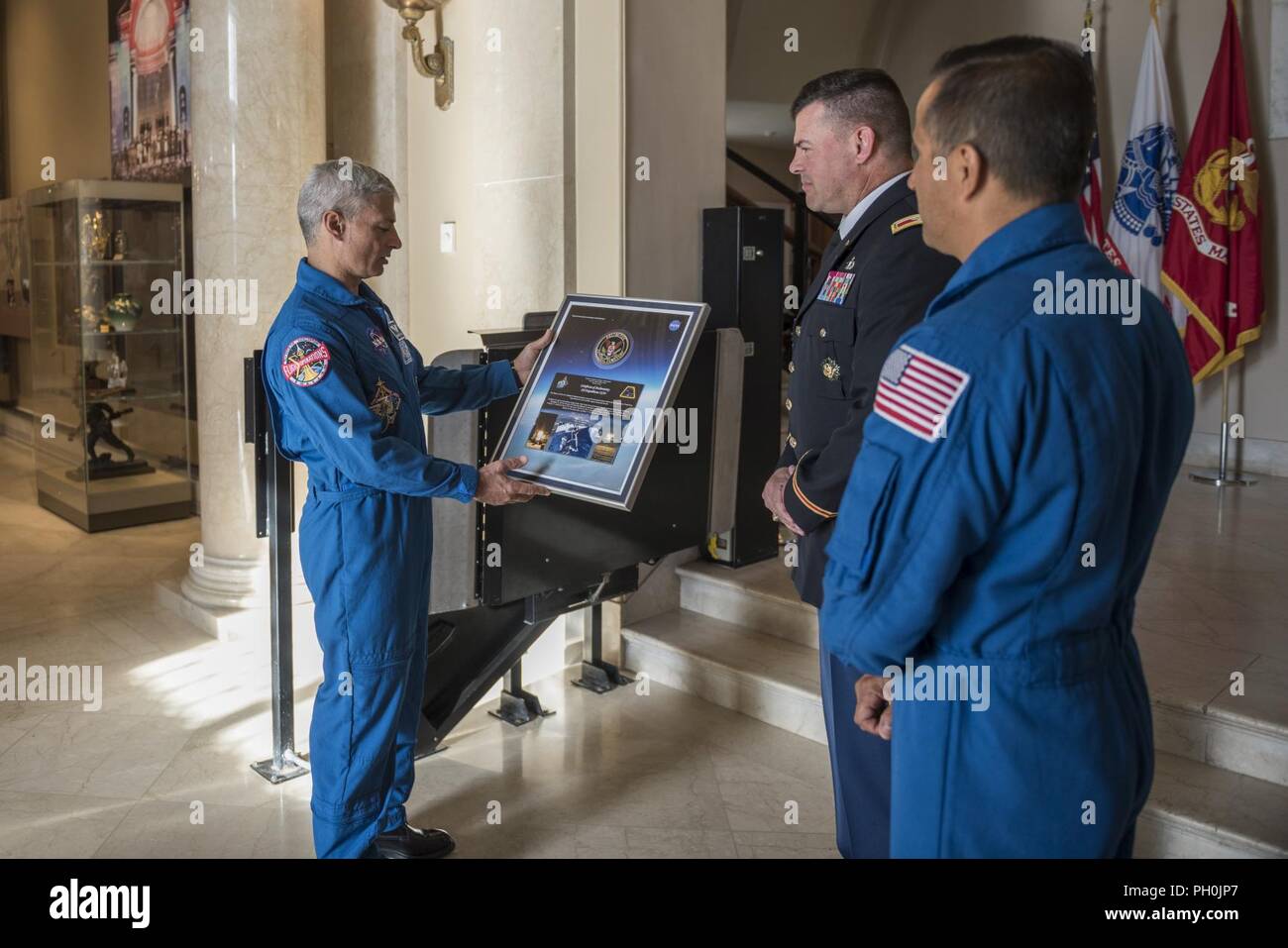 NASA astronauts Mark Vande Hei (center) and Joe Acaba (right) present ...