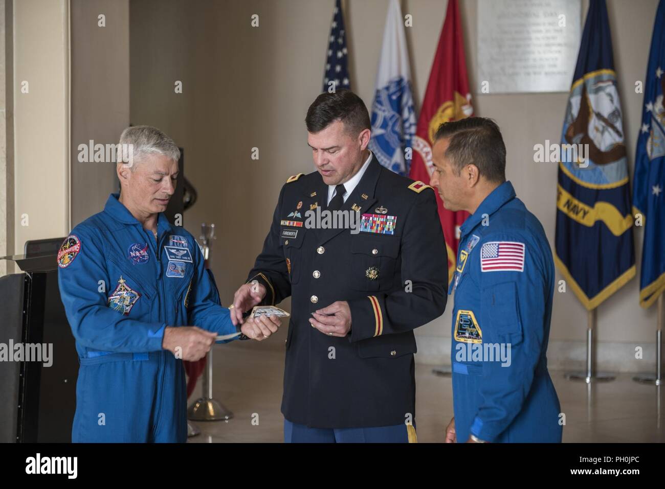 NASA astronauts Mark Vande Hei (center) and Joe Acaba (right) exchange ...