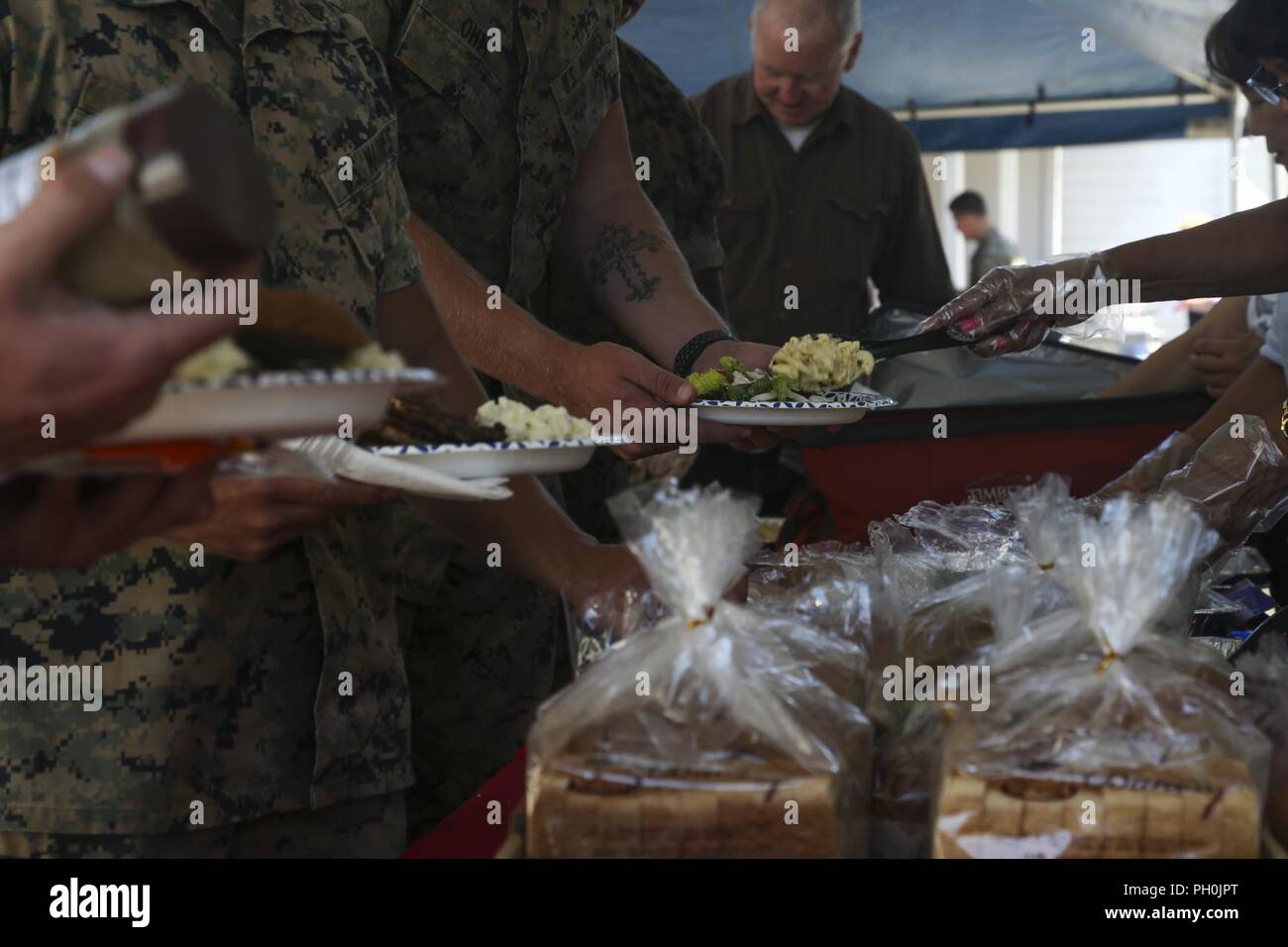 U.S. Marines, with 1st Marine Division, line up to grab food during a ...