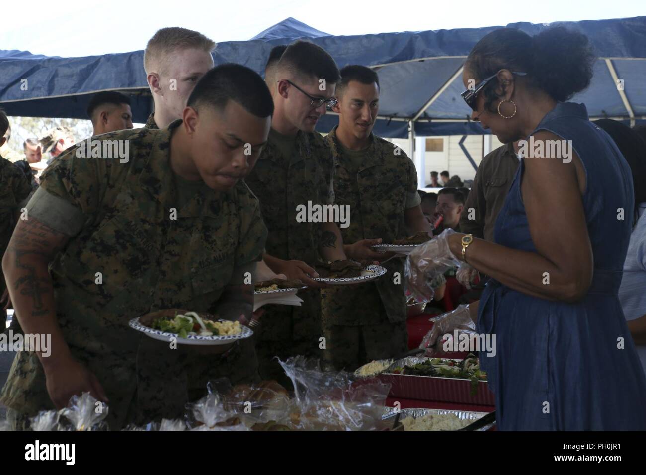 U.S. Marines, with 1st Marine Division, line up to grab food during a ...