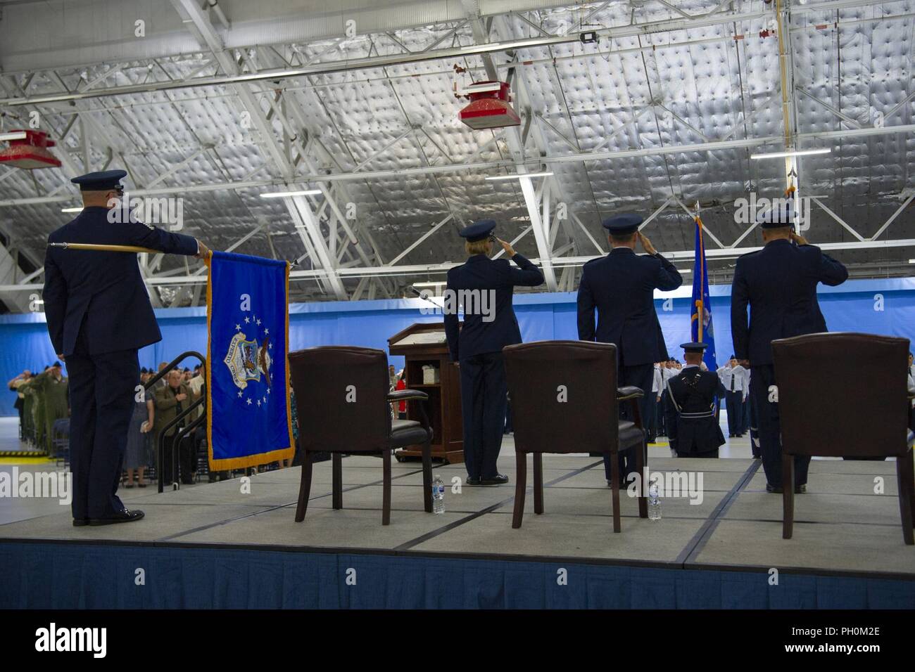 Leadership from the 89th Airlift Wing salute a formation during a ...