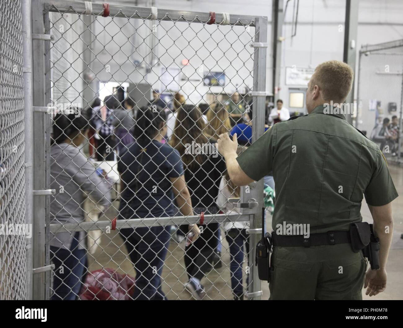 U.S. Border Patrol agents conduct intake of illegal border crossers at ...