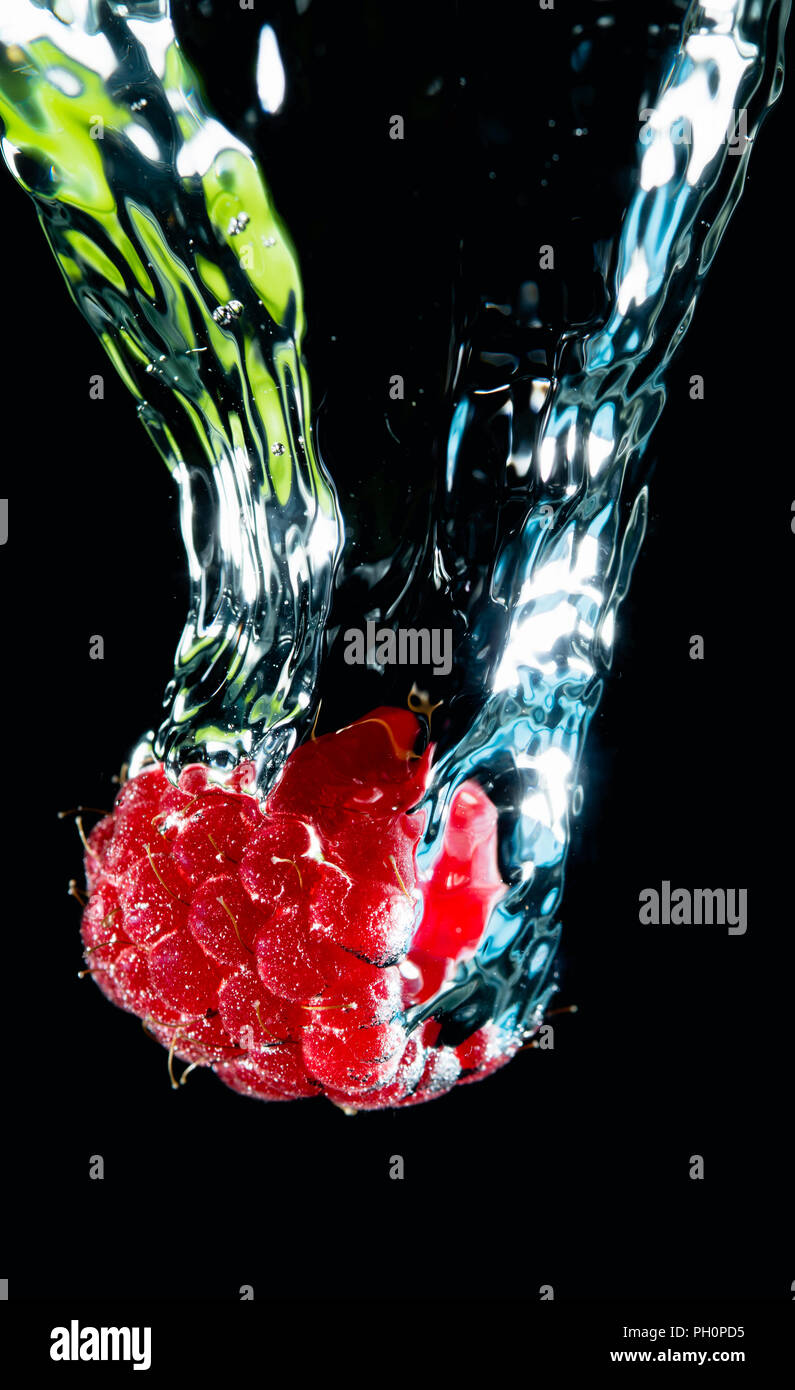 Fresh berry falling in water Stock Photo - Alamy