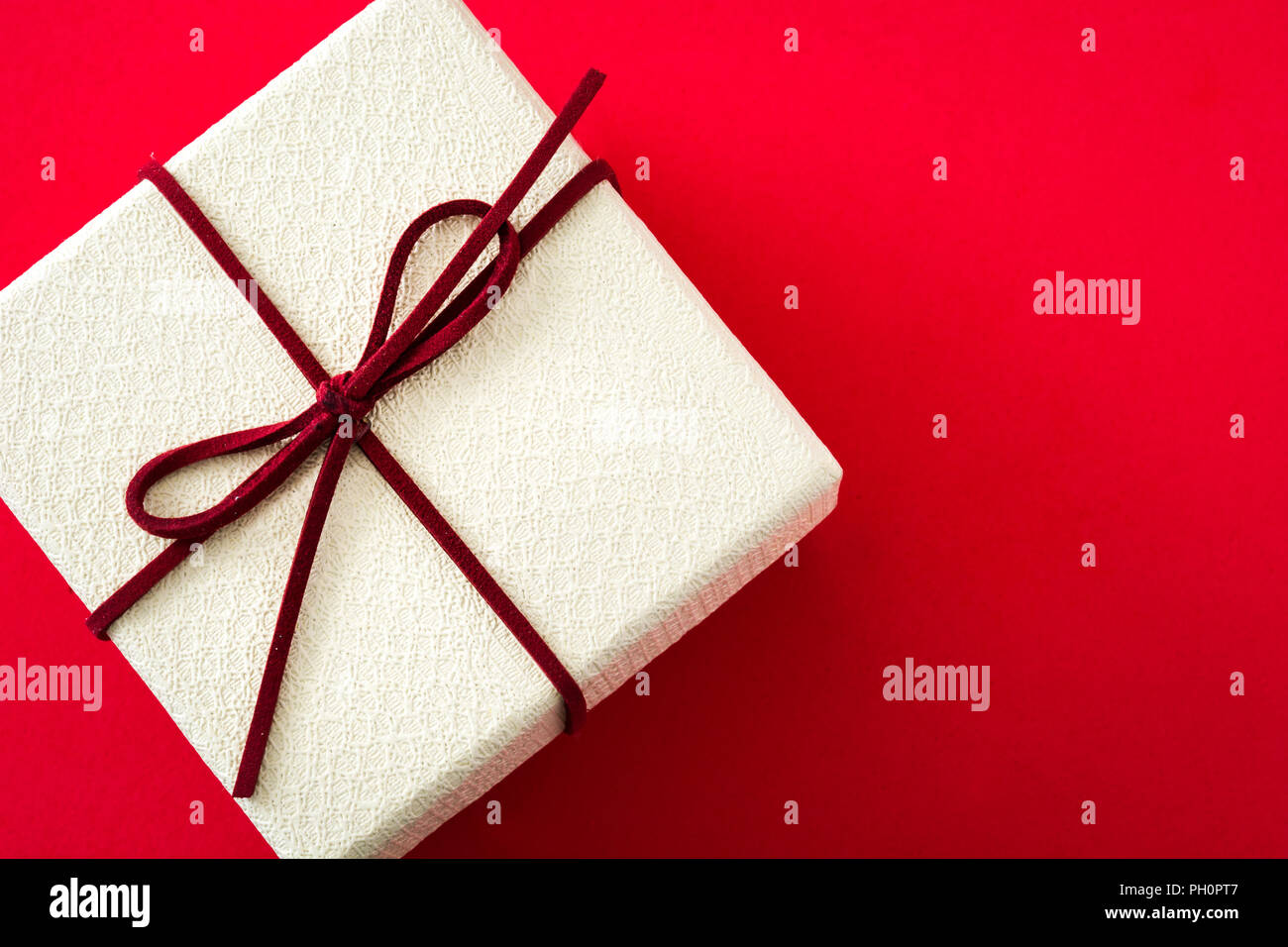 White gift box on red background. Copyspace Stock Photo - Alamy