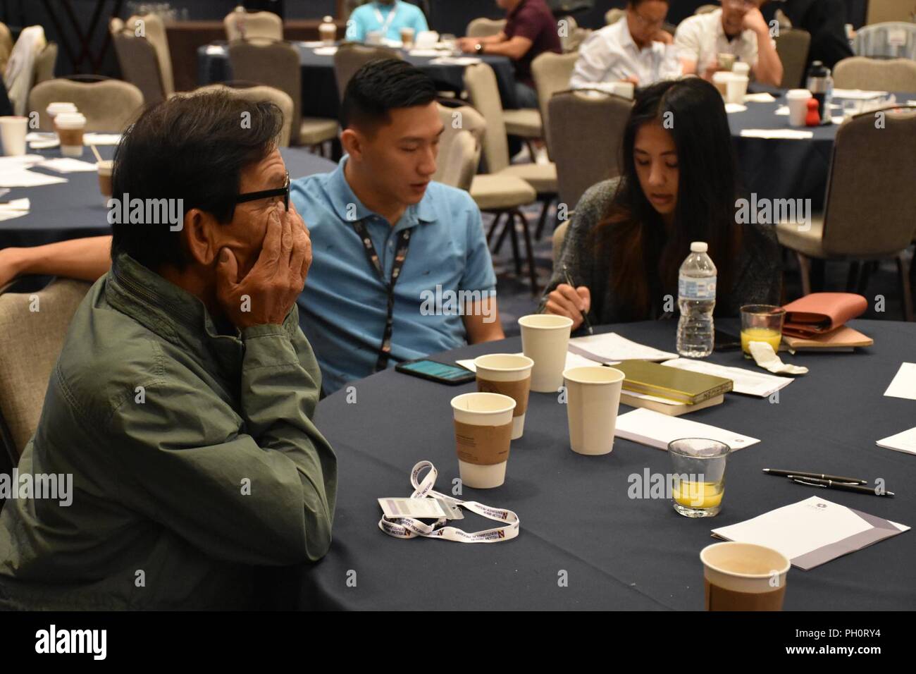 A father sits with his son, a U.S. Army Reserve Soldier preparing for ...