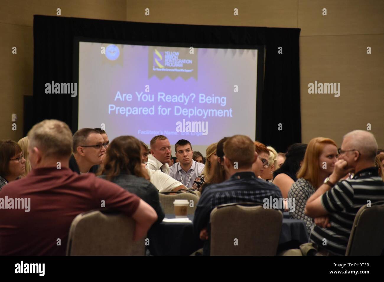 U.S. Army Reserve Soldiers and family members listen during the opening ...