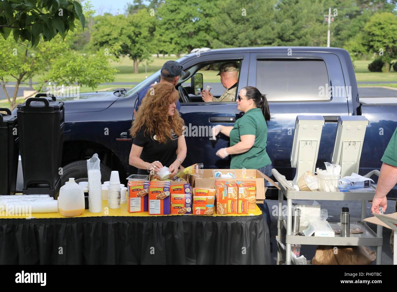 Fort McCoy, Wis., community members line up for a free drive-thru ...